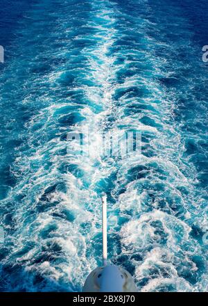 Trail on water surface behind of cruise ship Stock Photo - Alamy