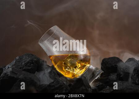 Whisky in a Glencairn Whisky Glass sitting on burning coal, whisky ...