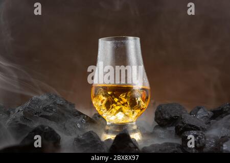 Whisky in a Glencairn Whisky Glass sitting on burning coal, whisky ...
