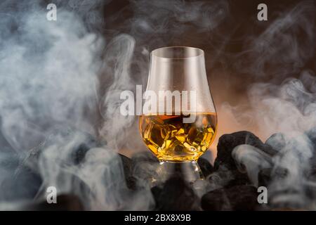 Whisky in a Glencairn Whisky Glass sitting on burning coal, whisky ...