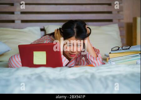 young frustrated and tired Asian Japanese university student girl ...