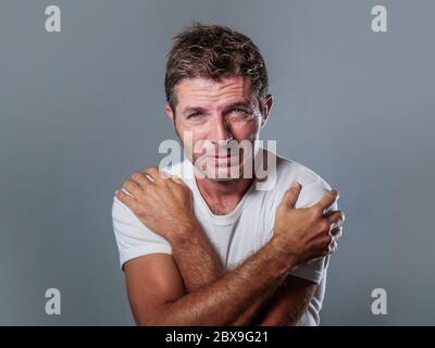 Crying guy hugging himself, feeling sad and lonely, standing unhappy on ...