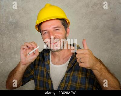 builder smoking cigarette in construction site Stock Photo - Alamy