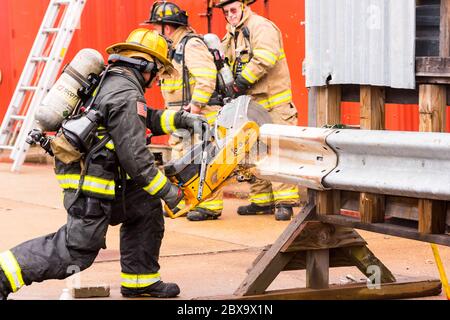 Firefighter learning the proper way to cut metal, using a highway ...