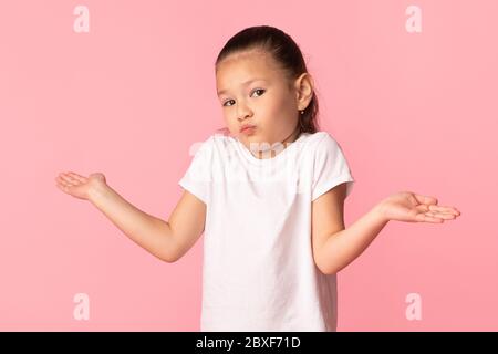 Confused puzzled asian kid shrugging at studio Stock Photo - Alamy