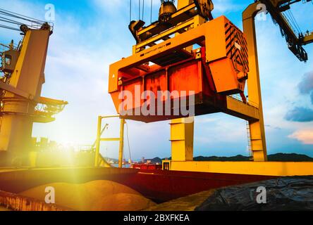 Raw sugar bulk loaded into large vessel hole by rotainer for export ...