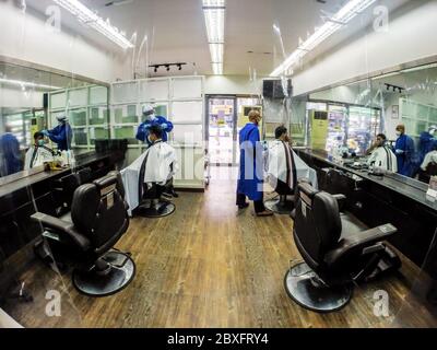 ,Barbers wearing Personal Protective Equipment (PPE) at work at a ...