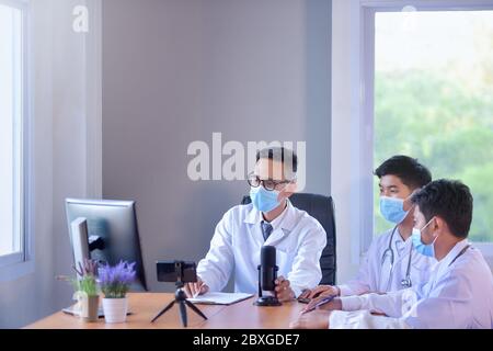 Three doctors having an online consultation with a patient Stock Photo ...