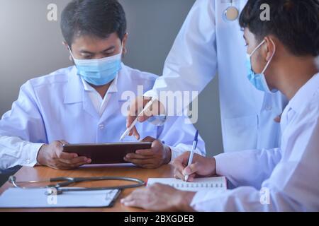 Three doctors having an online consultation with a patient Stock Photo ...