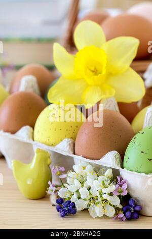 A box of decorative Easter egg decorations on a yellow surface Stock ...