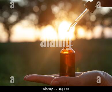 mint essential oil drop falling from dropper into the bottle Stock ...