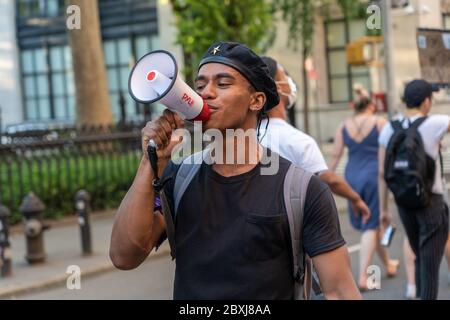 A Black Lives Matter demonstrator shouts into a megaphone during a ...