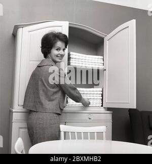 Linen cupboard with typical bedding and clothing from the Victorian era ...