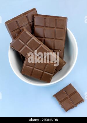 Chocolate isolated against a blue background with coffee mugs Stock ...
