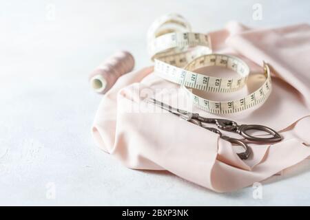 Everything for sewing. Beige fabric, sewing accessories and scissors ...
