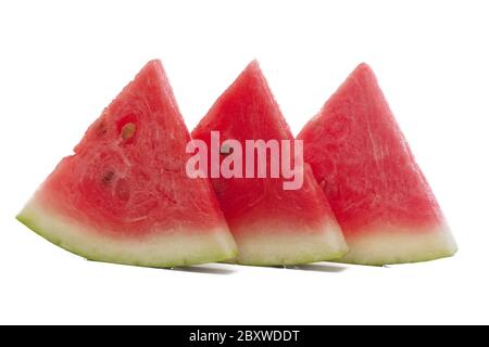 A row of three watermelon slices on black reflective surface Stock ...