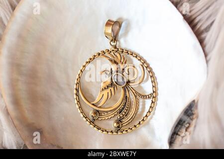 Brass pendant with Phoenix in round shape mandala on white shell ...