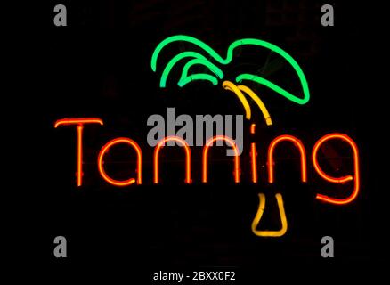 Neon Tanning Sign Stock Photo - Alamy