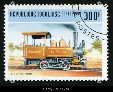 TOGOLESE REPUBLIC -CIRCA 1999: Ancient train with a steam locomotive ...