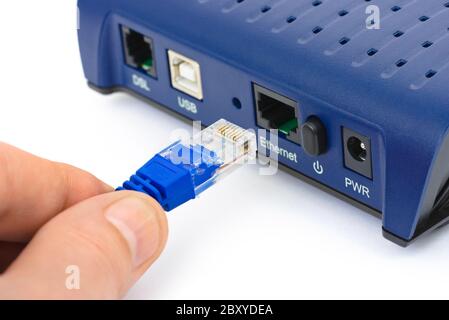 Internet cable in hand and modem Stock Photo - Alamy