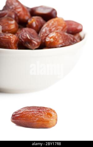 Dates in bowl isolated on a white background Stock Photo - Alamy