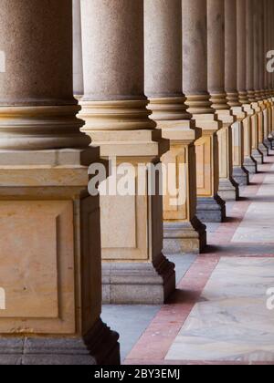 Architectural structure with row of concrete columns and wooden beams ...