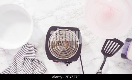 Flat lay. Making crepes in a small frying pan over medium heat Stock ...