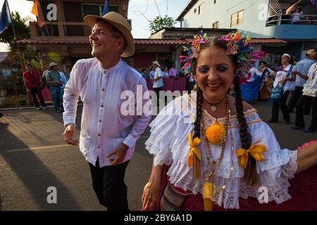 A Panamanian man and woman in traditional dress. The woman wears a ...