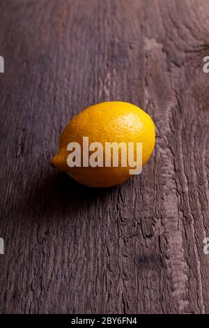 Fresh lemon on old rustic vintage wooden table. Top view with place for ...