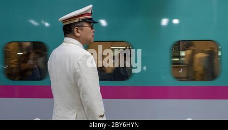 Station master conductor at Shinkanse platform terminal in Tokyo ...