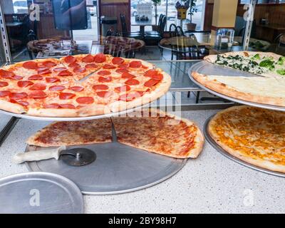 Pizza and pizza making Pizza on display at counter Stock Photo - Alamy