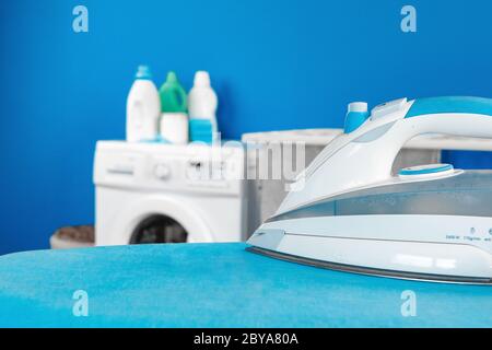 Housekeeping concept. Washing machine and ironing board Stock Photo - Alamy