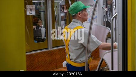 Cleaner workers cleaning Tokyo Metro subway train Stock Photo - Alamy