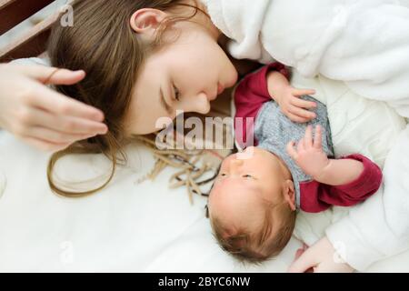 Teenage girl holding newborn baby Stock Photo - Alamy