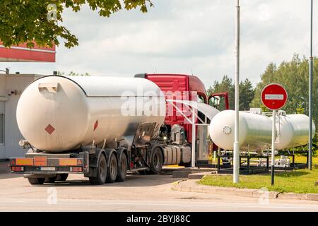 Fuel tanker truck unloading at a service station, unloading with two ...