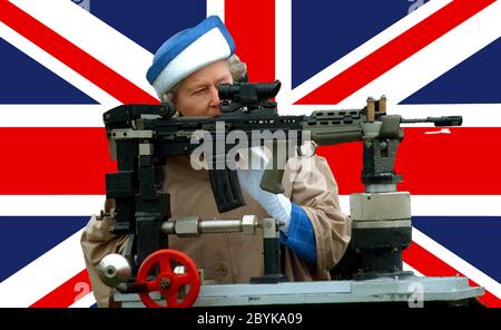HM Queen Elizabeth II fires a rifle during a visit to the Army rifle ...