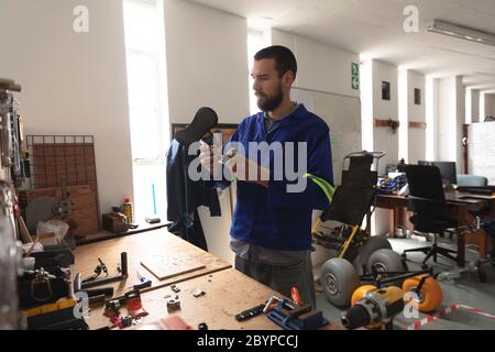 Worker inspecting a wheelchairs part Stock Photo - Alamy