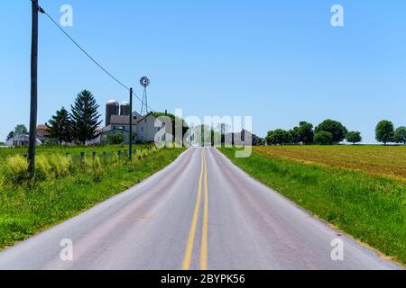 Gordonville, PA, USA / June 8, 2020: Two young Amish girls ride in a ...