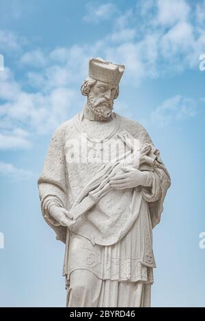 Statue of priest with figure of crucified Jesus in Vienna downtown at ...