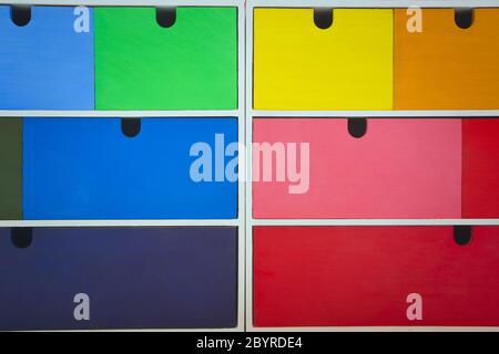 colorful wooden drawers in various colors, modern interior background ...