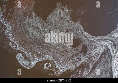 Aerial view of changing patterns of foam on the surface of the water ...