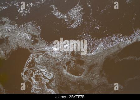 Aerial view of changing patterns of foam on the surface of the water ...