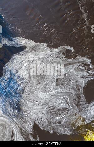 Aerial view of changing patterns of foam on the surface of the water ...