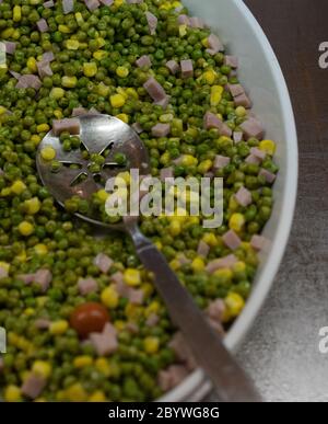 Frozen sweet corn in a bowl with a wooden spoon Stock Photo - Alamy