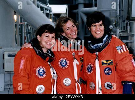 STS-83 Mission Specialist Donald A. Thomas is assisted into his launch/entry suit in the ...