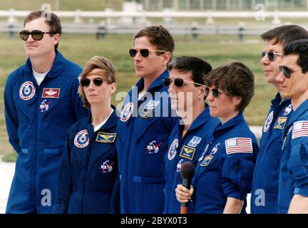STS-83 Pilot Susan L. Still gives a thumbs-up as she is assisted into ...