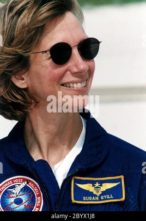 STS-83 Pilot Susan L. Still gives a thumbs-up as she is assisted into ...