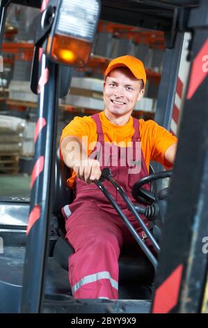 Professional warehouse worker driver moving cardboard boxes Stock Photo ...