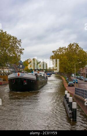 Barge navigating the Rijn-Schiekanaal in Delft, and approaching the ...