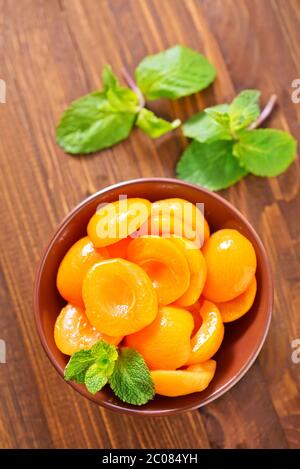 Canned apricots with mint leaves Stock Photo - Alamy